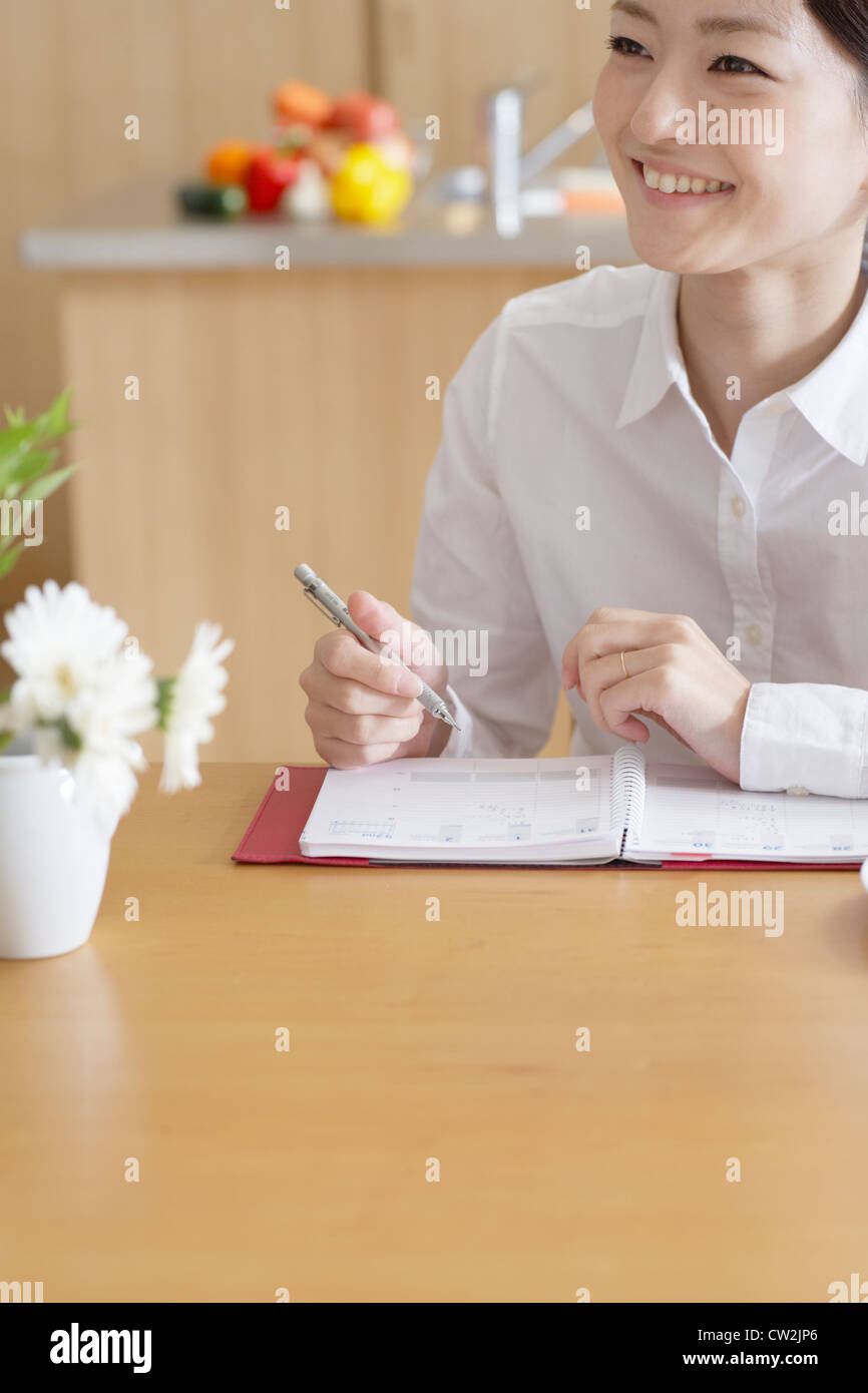 Woman writing a diary Stock Photo - Alamy