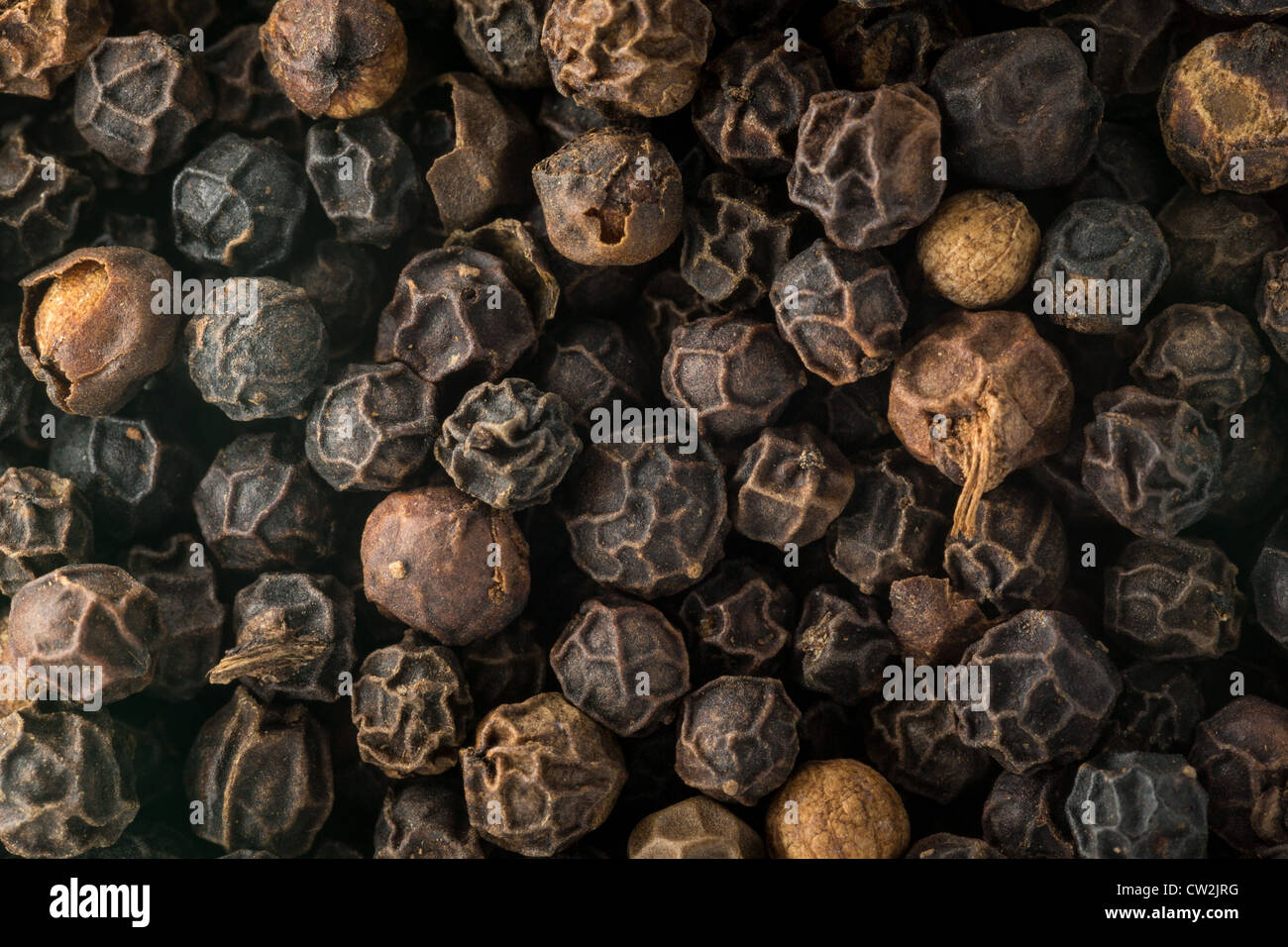 Black pepper corn seeds in macro photo Stock Photo - Alamy