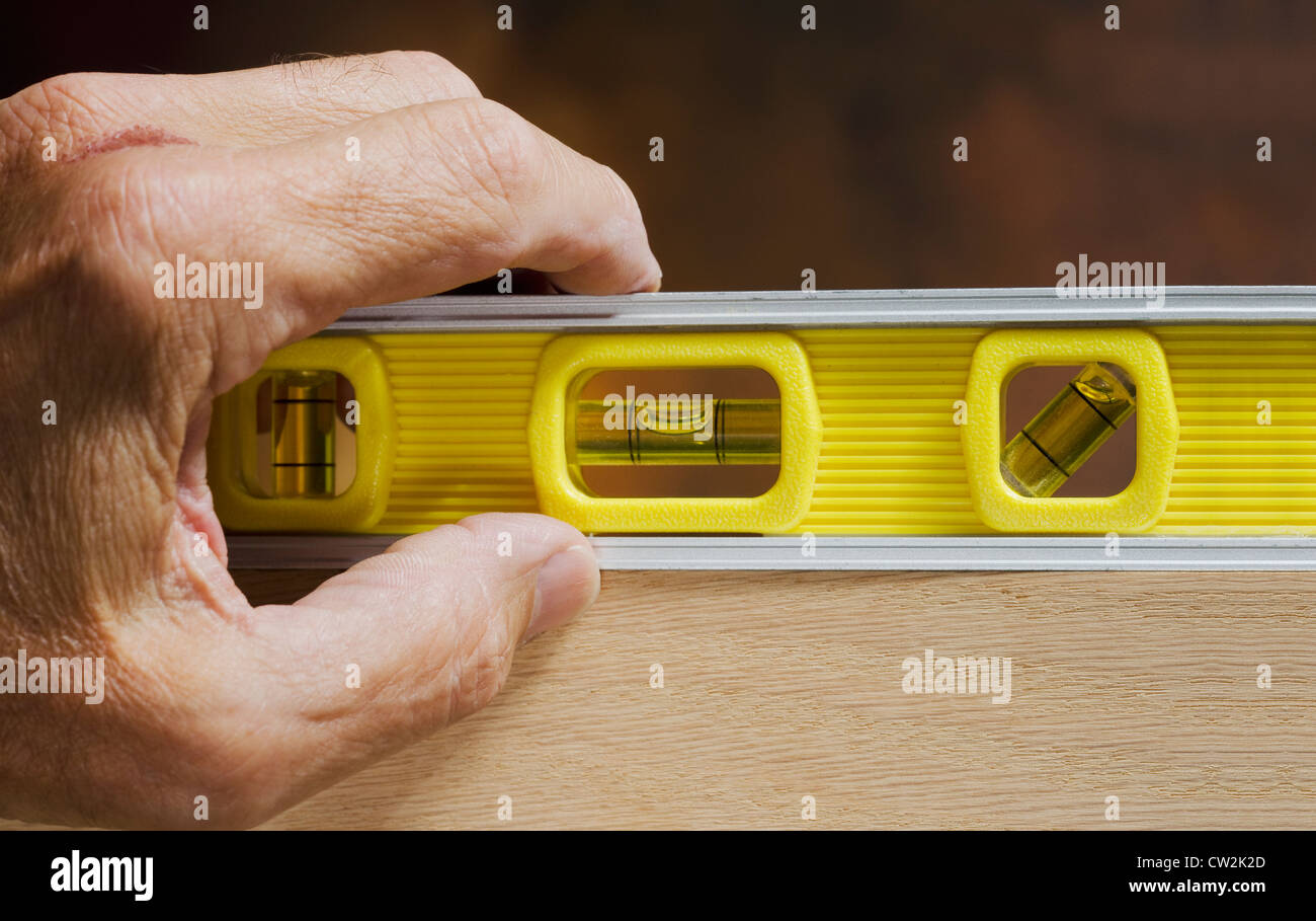 close-up of hand on carpenter level Stock Photo - Alamy