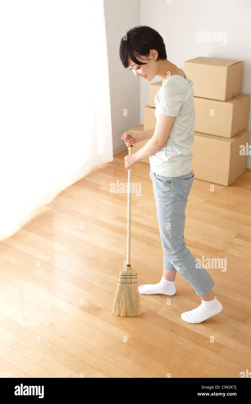 Woman cleaning living room Stock Photo - Alamy