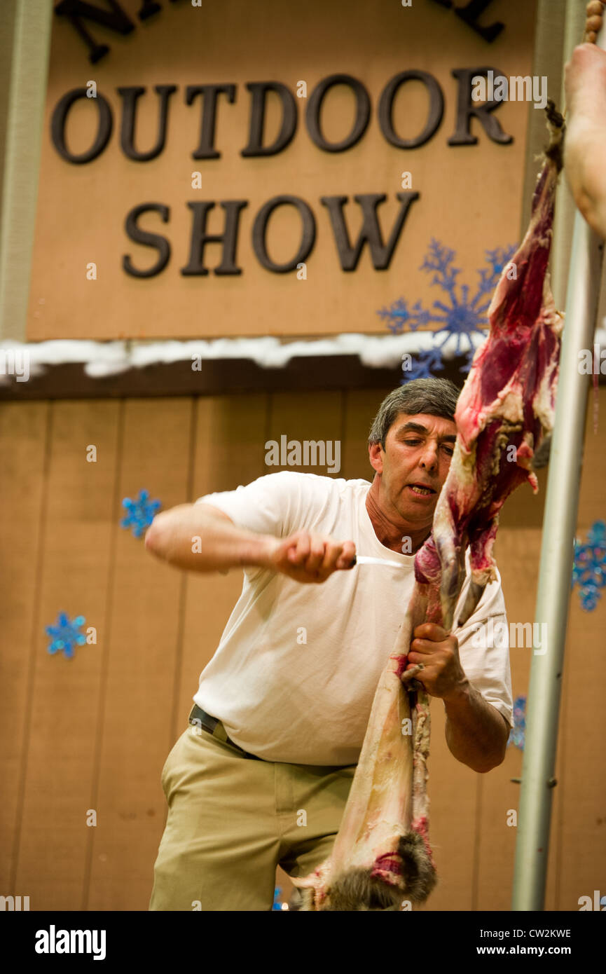 Man skinning a muskrat at the National Outdoor Show and World Muskrat ...