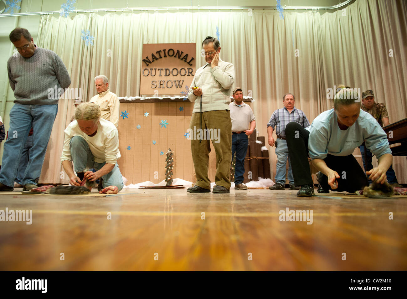 Judge and men skinning a muskrat at the National Outdoor Show and World ...
