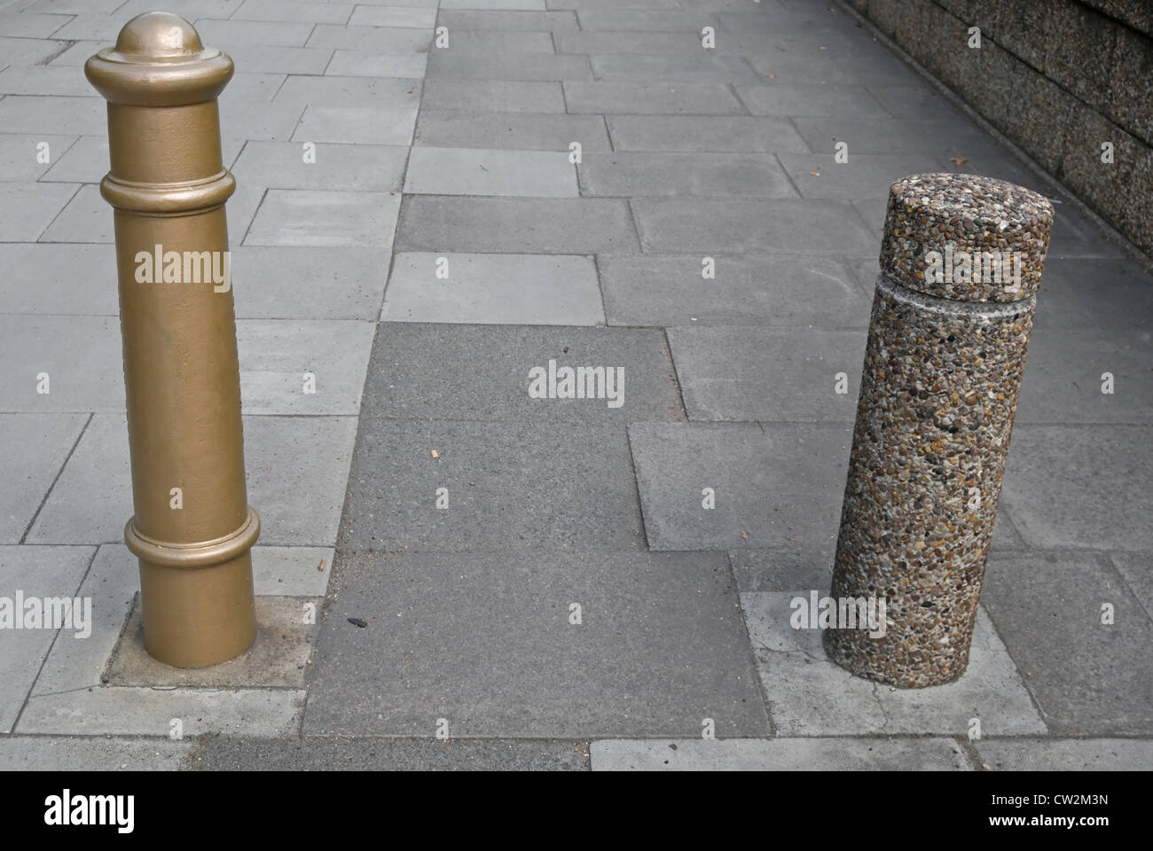 mismatched bollards in pavement Stock Photo - Alamy