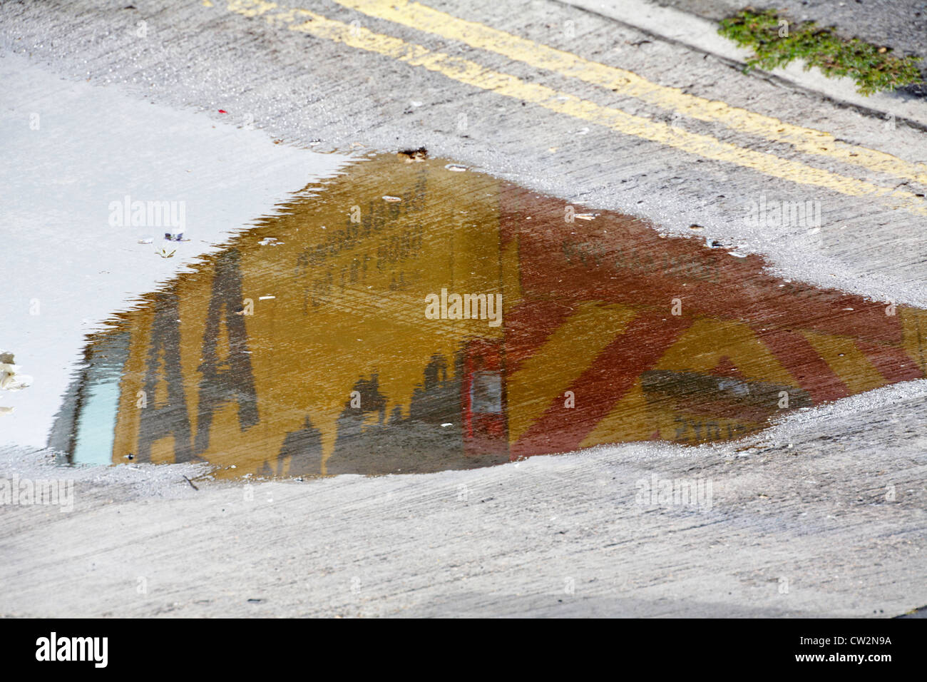 Reflection of AA van in puddle at Weymouth in August Stock Photo - Alamy