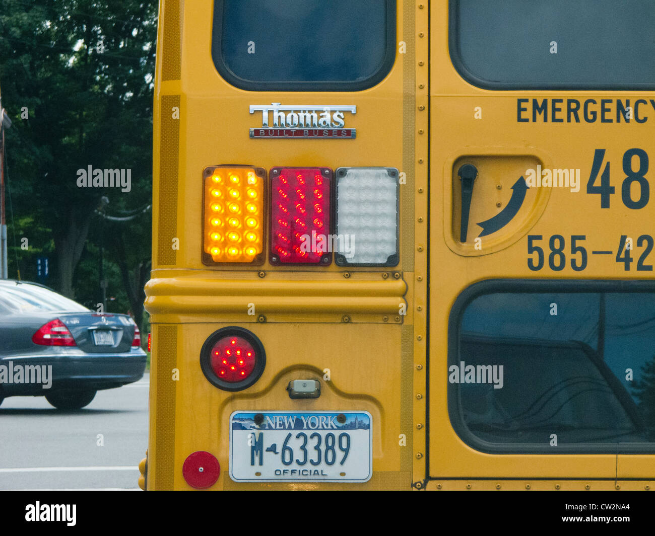 Rear of school bus in traffic Stock Photo - Alamy