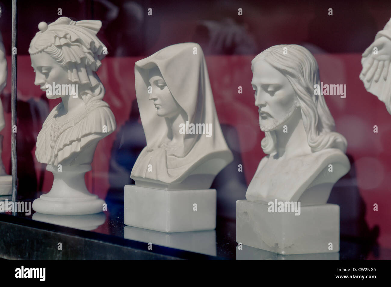 A display cabinet of white religious busts Stock Photo - Alamy