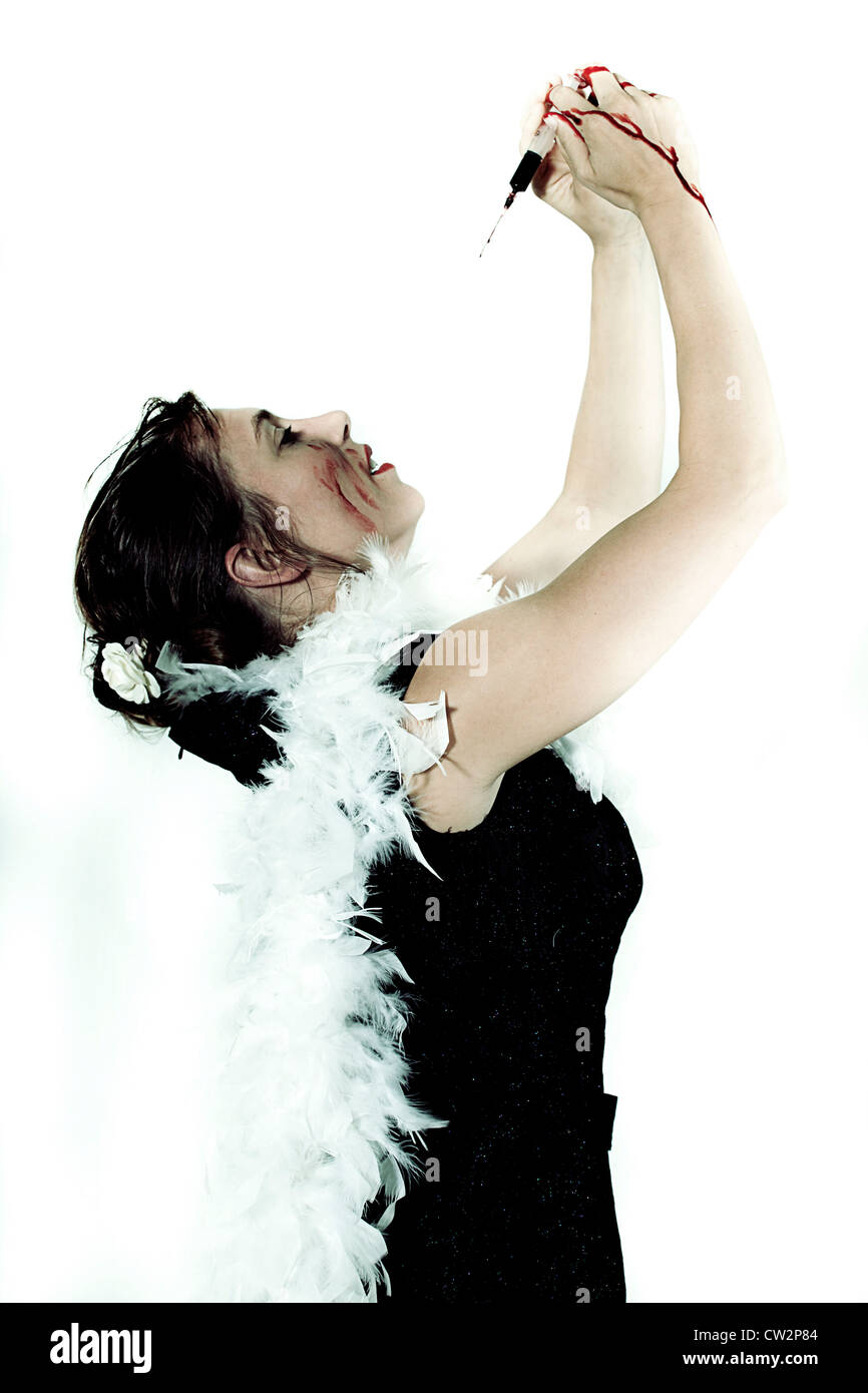 a woman holding a bloody syringe in her hands Stock Photo - Alamy
