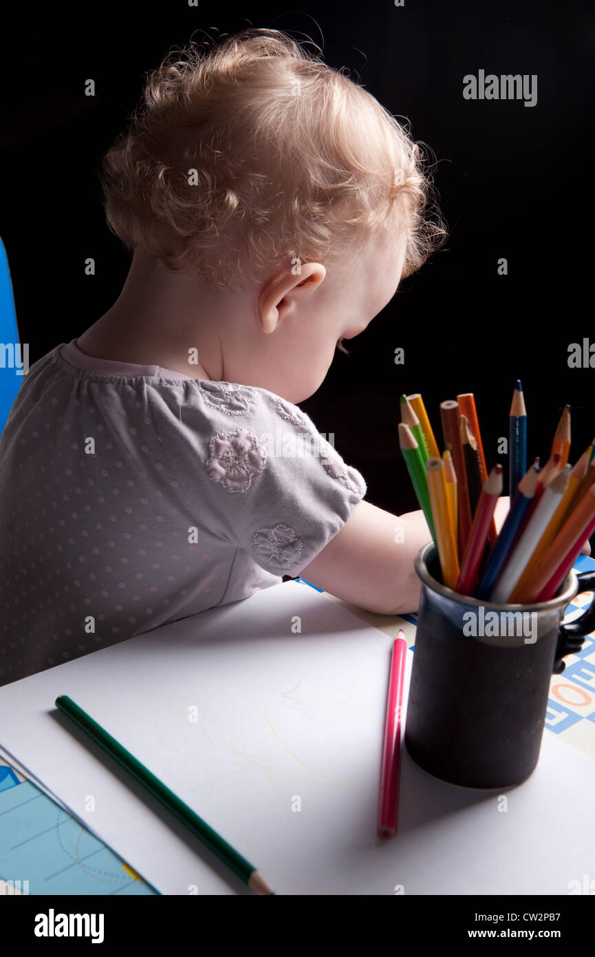Little baby girl drawing with colorful pencils Stock Photo - Alamy