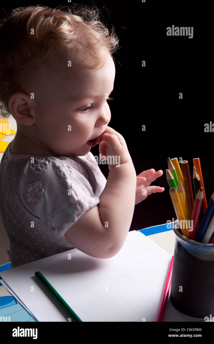 Little baby girl drawing with colorful pencils Stock Photo - Alamy