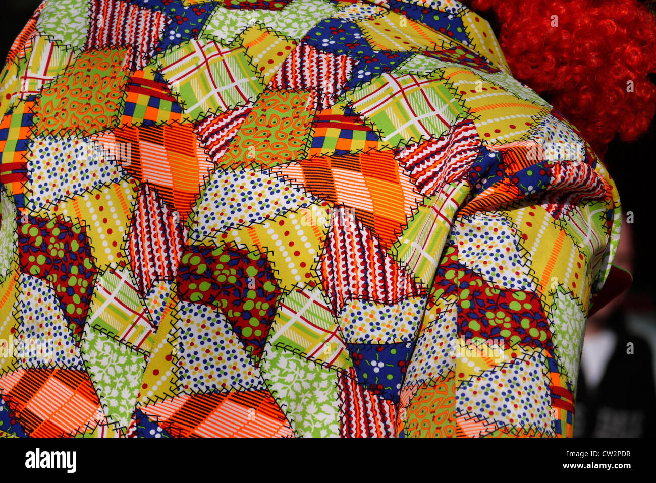 Back view of a Clown in a multi coloured stitched jacket Stock Photo ...