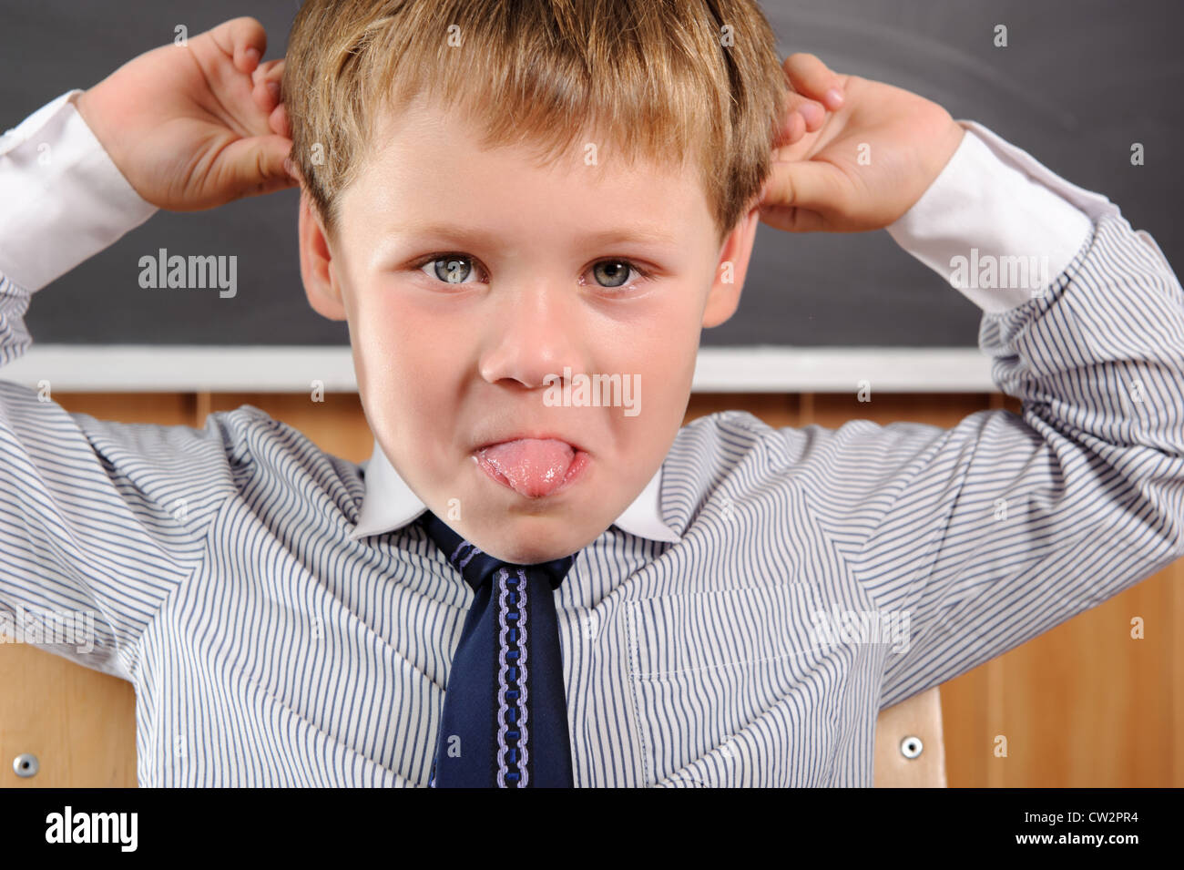 Funny preschool aged boy fooling in classroom Stock Photo - Alamy