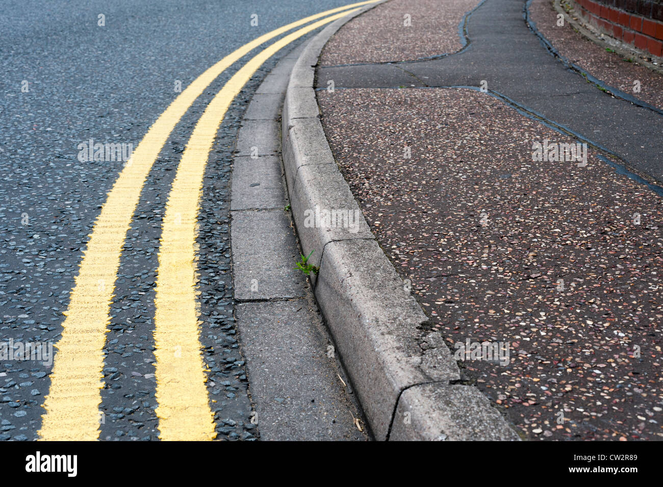 Double yellow lines on a road close up Stock Photo - Alamy