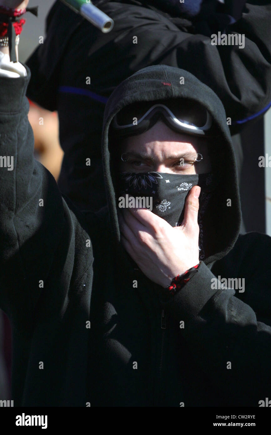 A protester with his face covered during a large anti war rally leading ...
