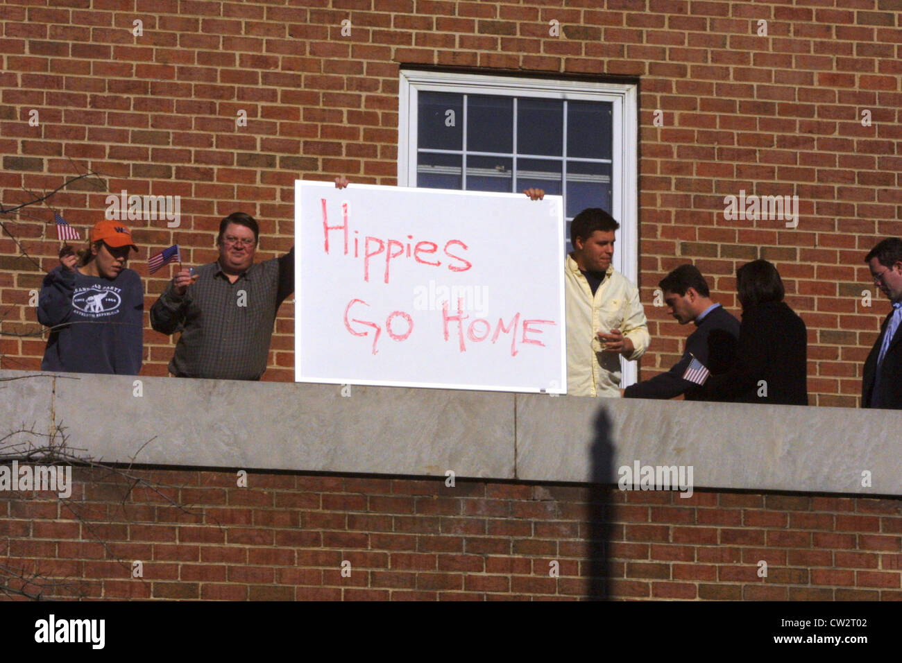 Republican supporters hold up a sign reading "Hippies Go Home", during ...