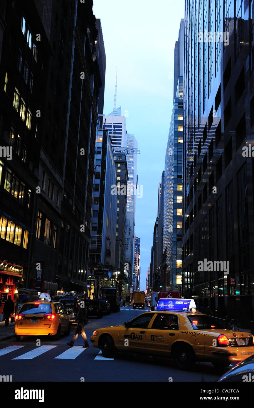 Dawn 'urban alley' portrait brown suit woman crossing, headlights taxi ...