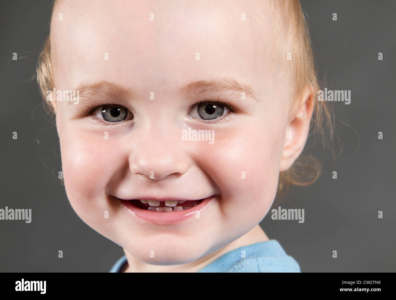 portrait of young child on grey background Stock Photo - Alamy