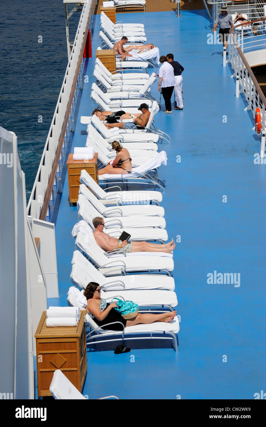 Passengers enjoy amenities on cruise ship sun pool tan relax Stock ...