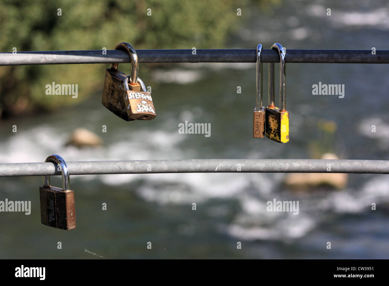 Love lock attached on a river bridge, Italy Stock Photo - Alamy
