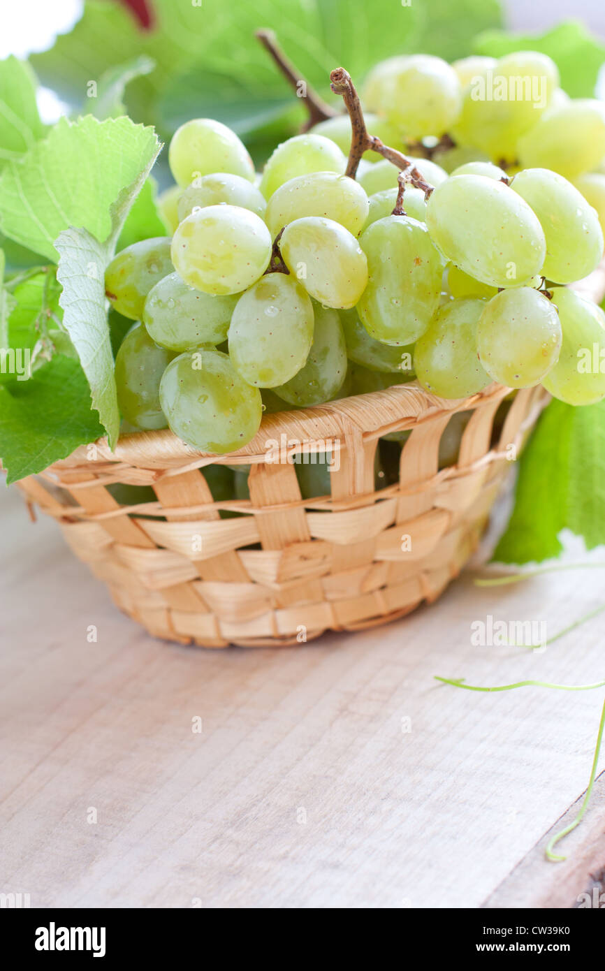 Muscat grapes in a wicker basket on the board, macro Stock Photo - Alamy