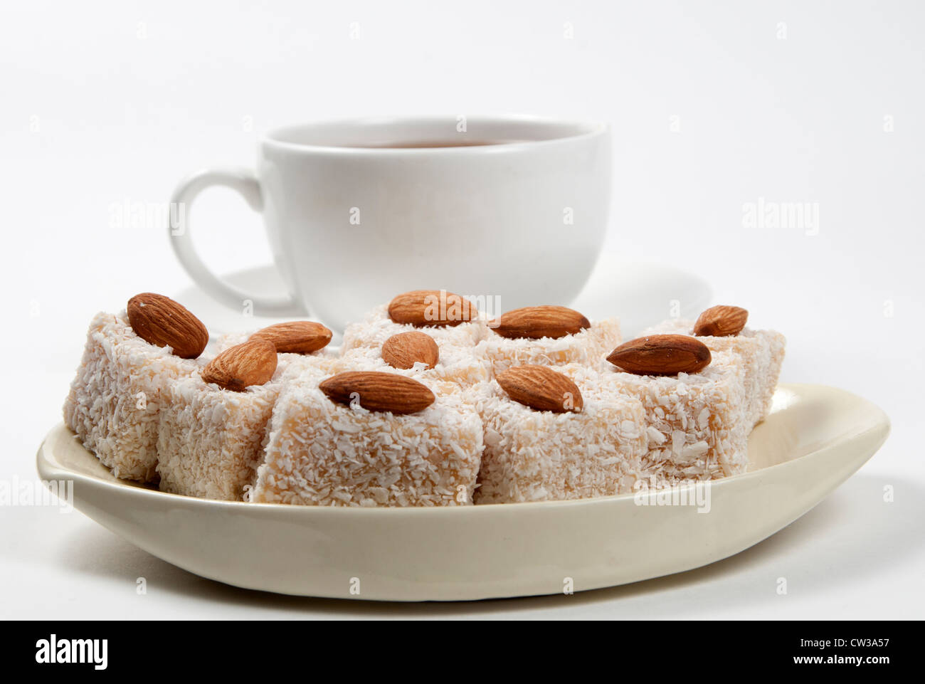 Turkish delight with almond nuts on a dish and tea Stock Photo - Alamy
