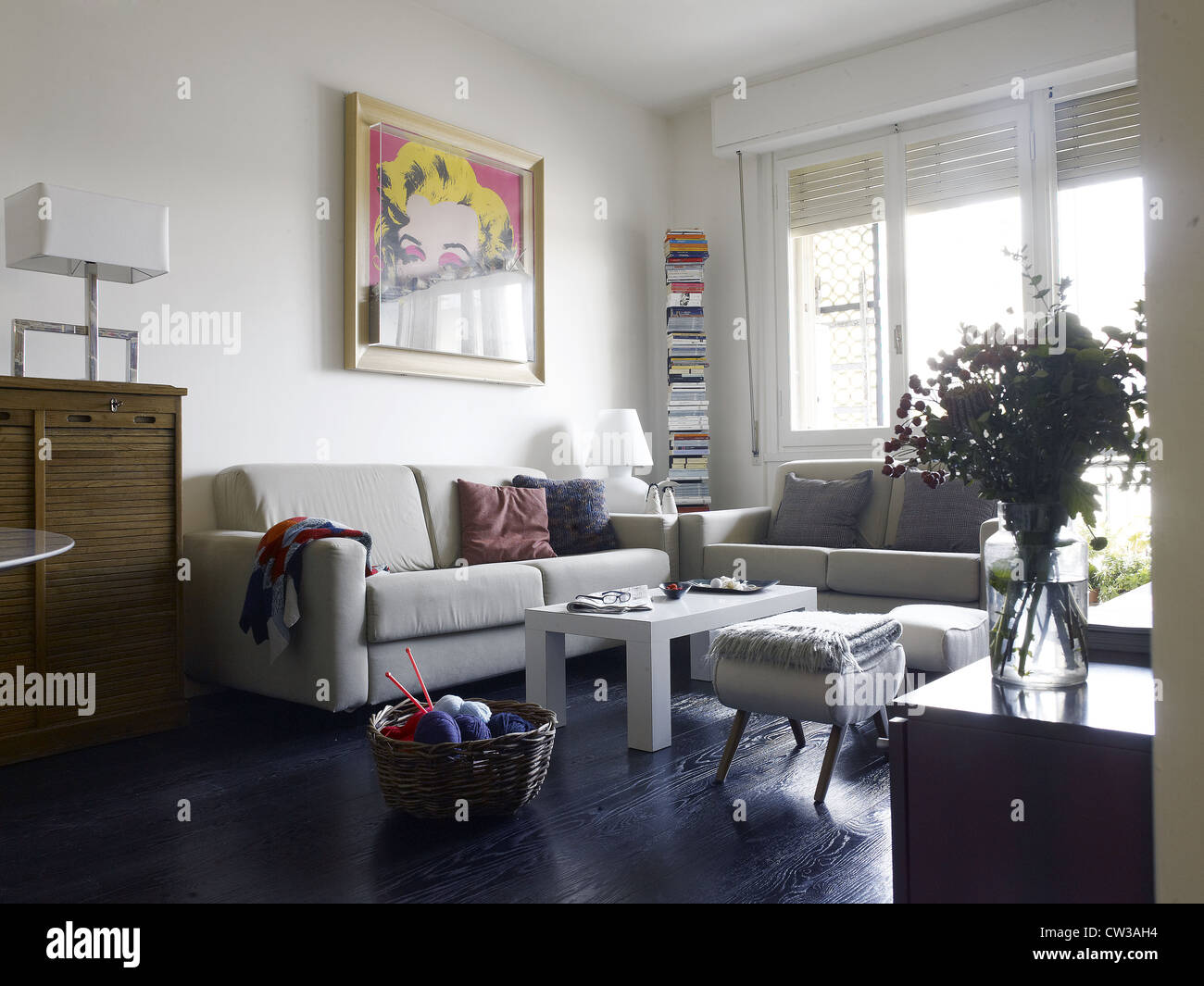 Living room in a modern italian flat with sofa and a small table and ...