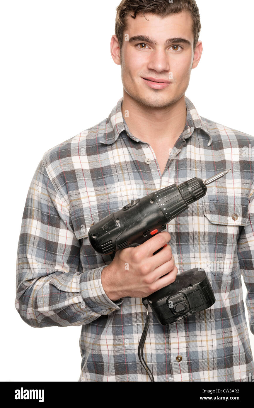 Smiling young man with drill machine in front of white background Stock ...