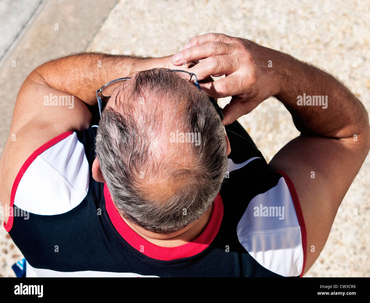 Obese balding man (from above) speaking on portable telephone - France ...