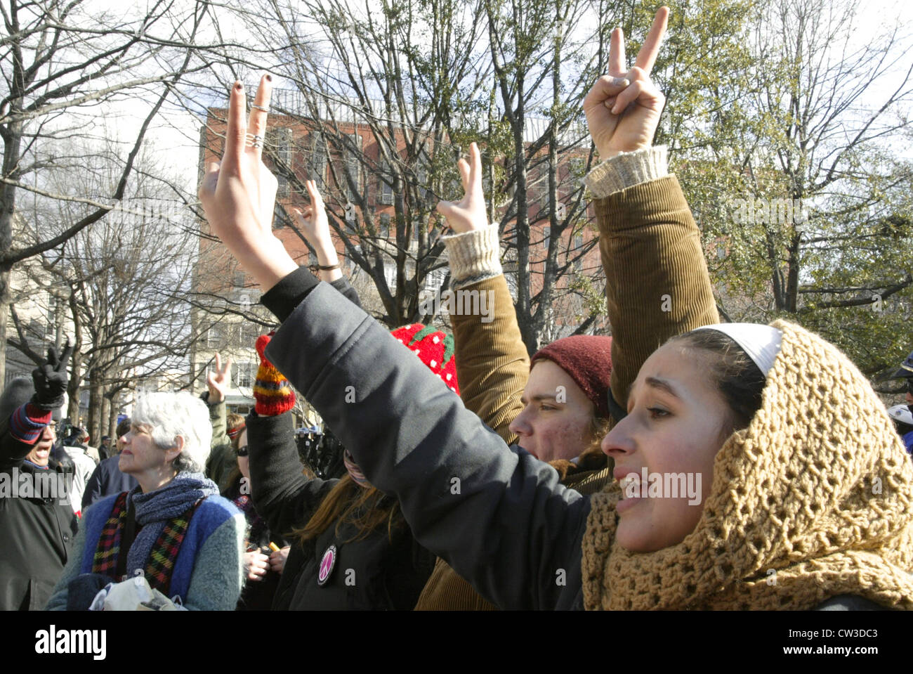 Protesters hold up peace signs while singing outside of Pershing Park ...