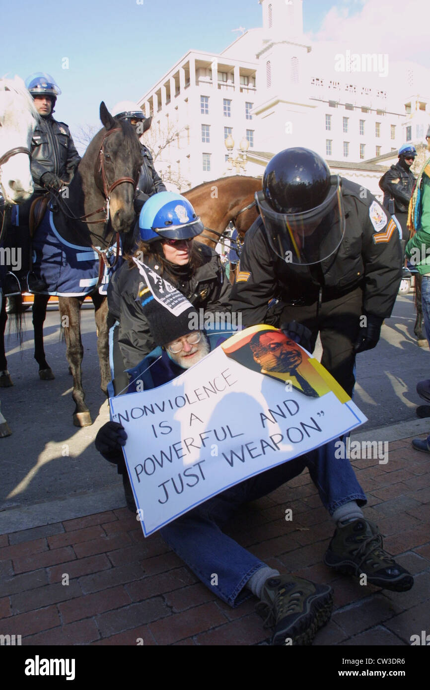 US Park Police clear the streets of a sitting protester wearing a sign ...