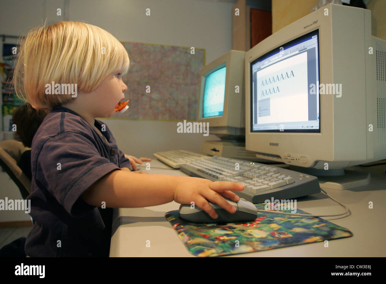 Berlin, a small child sitting in front of a computer Stock Photo - Alamy