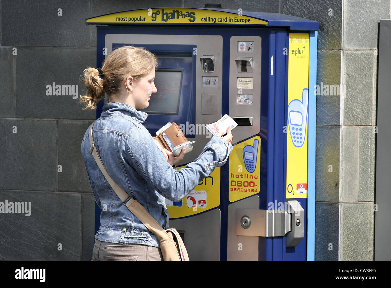 Esslingen, young woman when buying a phone card vending machines Stock ...