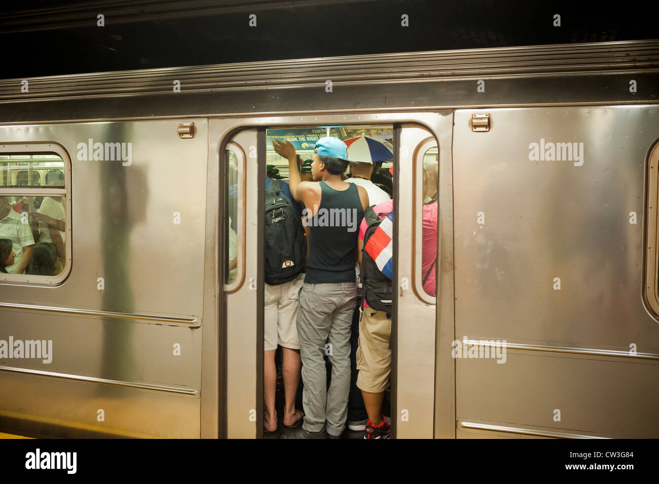 Revelers crowd the Number One train after the Dominican Day Parade in ...