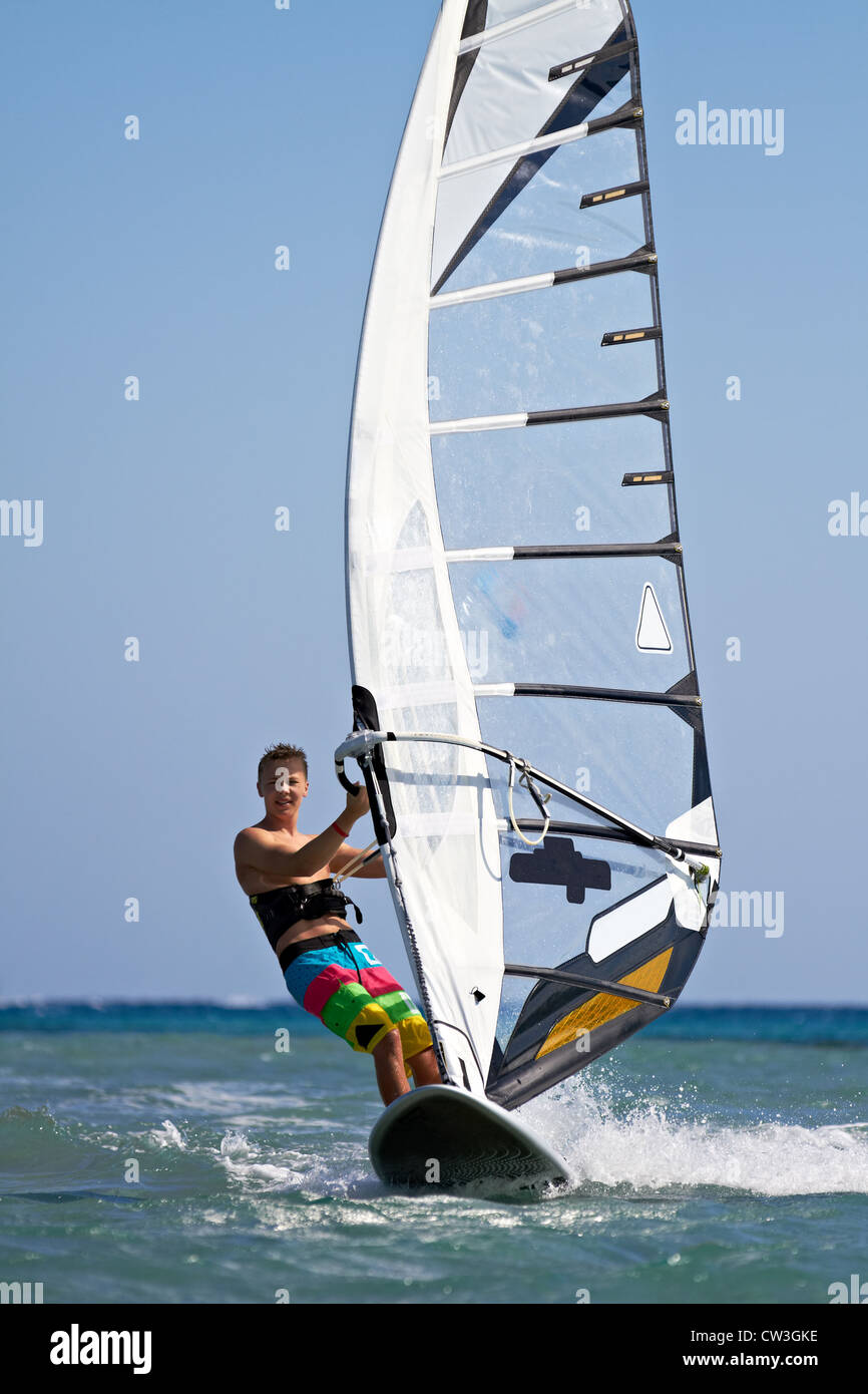 Front view of a windsurfer passing by Stock Photo - Alamy