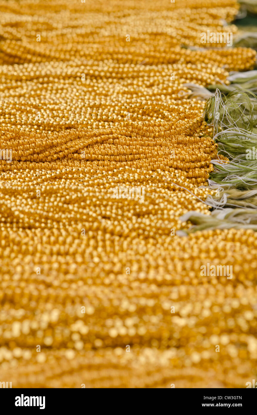 Ecuador, Quito area, Otavalo Market. Traditional gold beaded necklaces ...