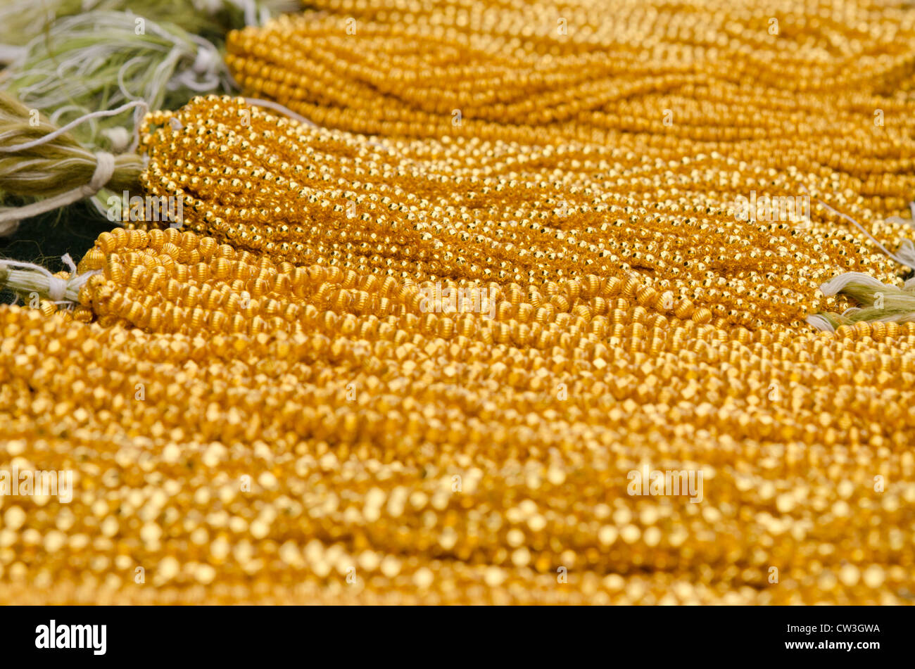 Ecuador, Quito area, Otavalo Market. Traditional gold beaded necklaces ...