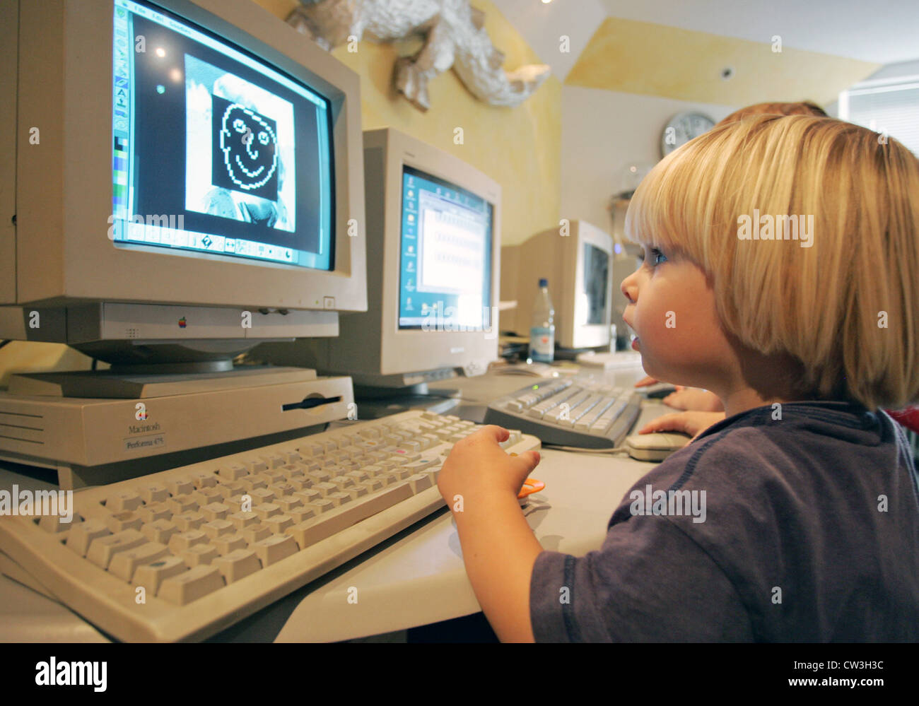 Berlin, a small child sitting in front of a computer Stock Photo - Alamy