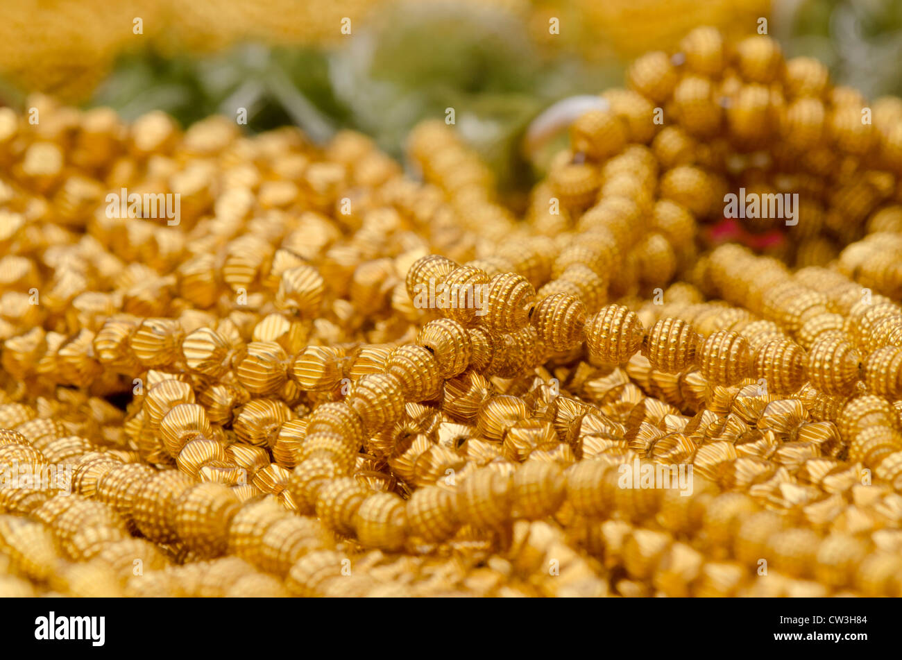 Ecuador, Quito area, Otavalo Market. Traditional gold beaded necklaces ...