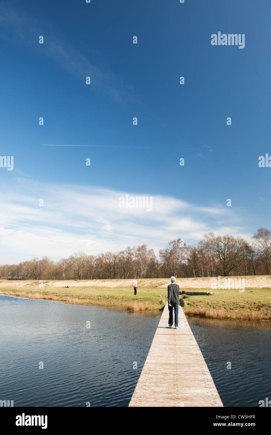Wooden platforms in nature water lake with walking man Stock Photo - Alamy