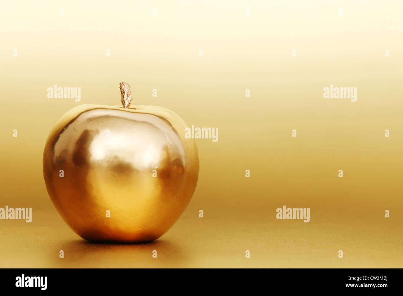 gold apple on gold background Stock Photo - Alamy