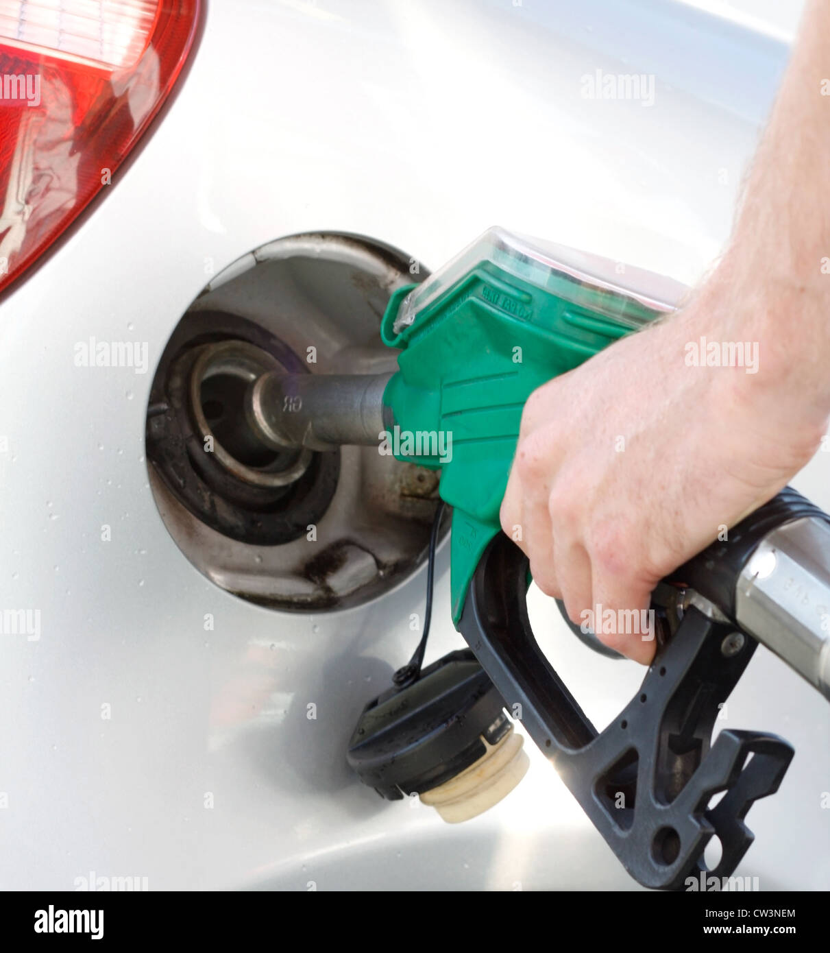 A man pumping gas in to the tank Stock Photo - Alamy