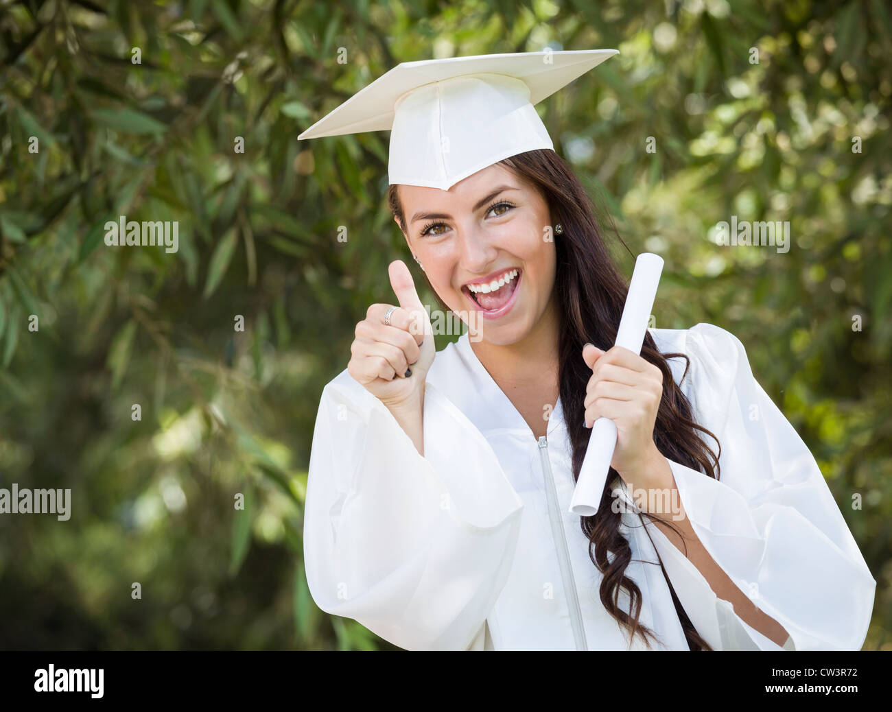 Attractive Mixed Race Girl Celebrating Graduation Outside In Cap and ...