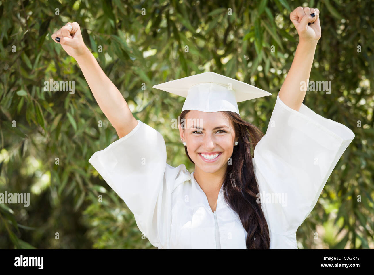 Attractive Smiling Mixed Race Girl Celebrating Graduation Outside In ...