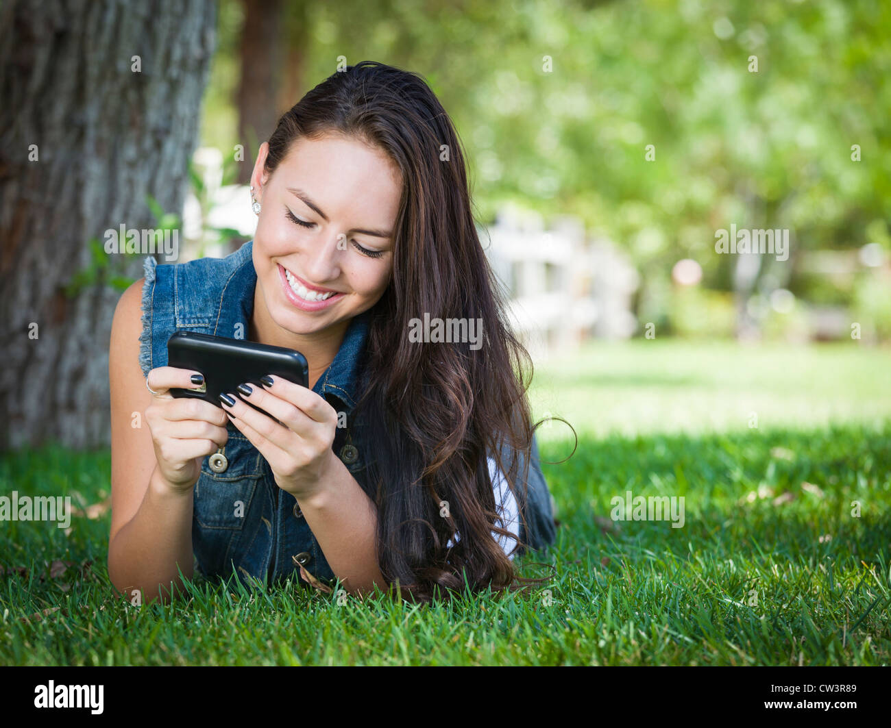 Attractive Happy Mixed Race Young Female Texting on Her Cell Phone ...