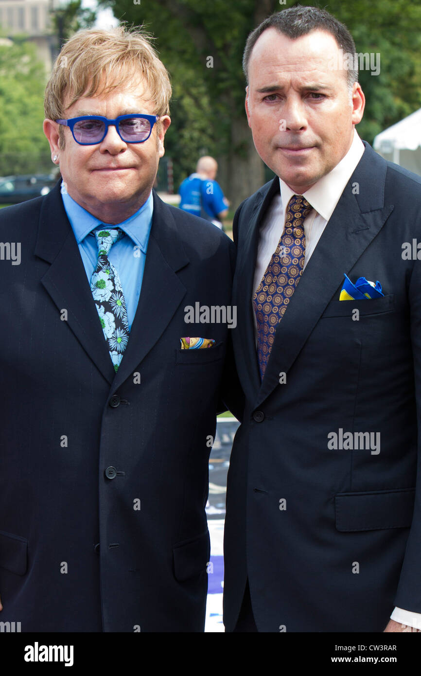 Elton John and his partner David Furnish visit the AIDS Quilt display ...