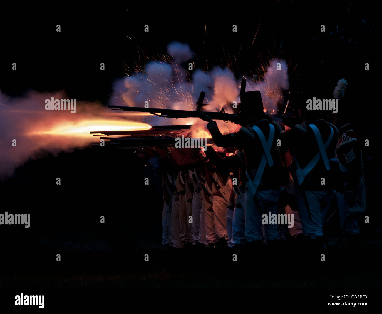 British Infantry re enactors firing their muskets in a night battle re ...