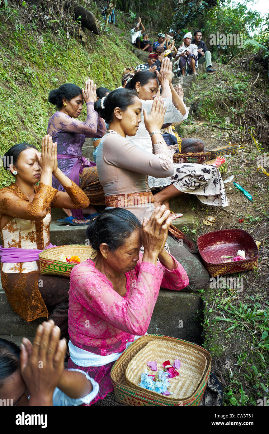 Locals pray by a water irrigation project behind a Balinese Hindu high ...