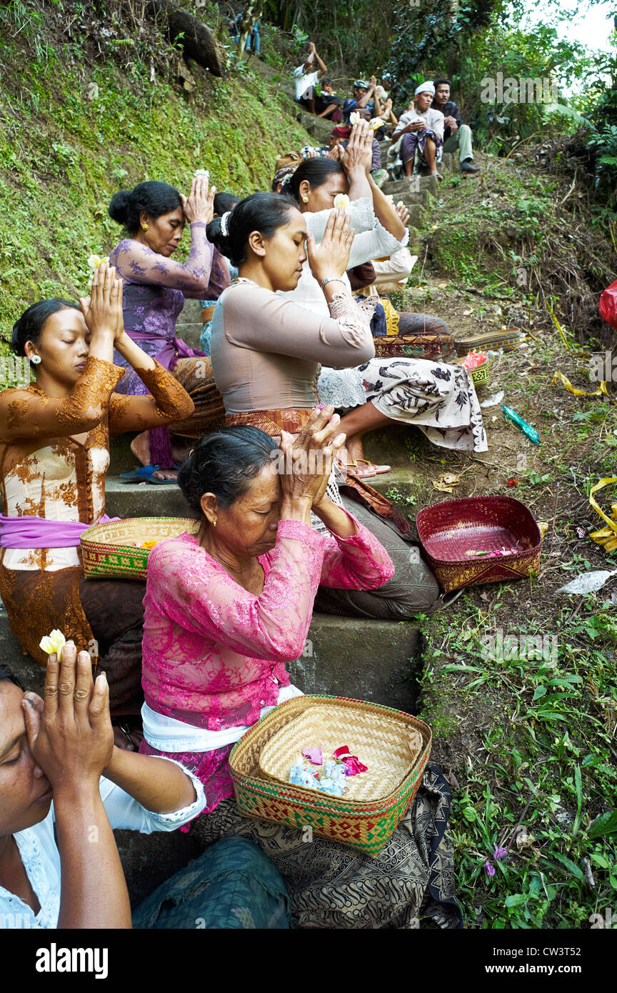 Locals pray by a water irrigation project behind a Balinese Hindu high ...