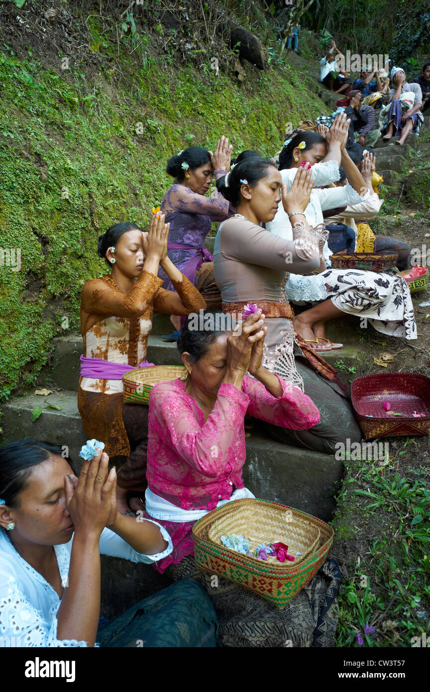 Locals pray by a water irrigation project behind a Balinese Hindu high ...