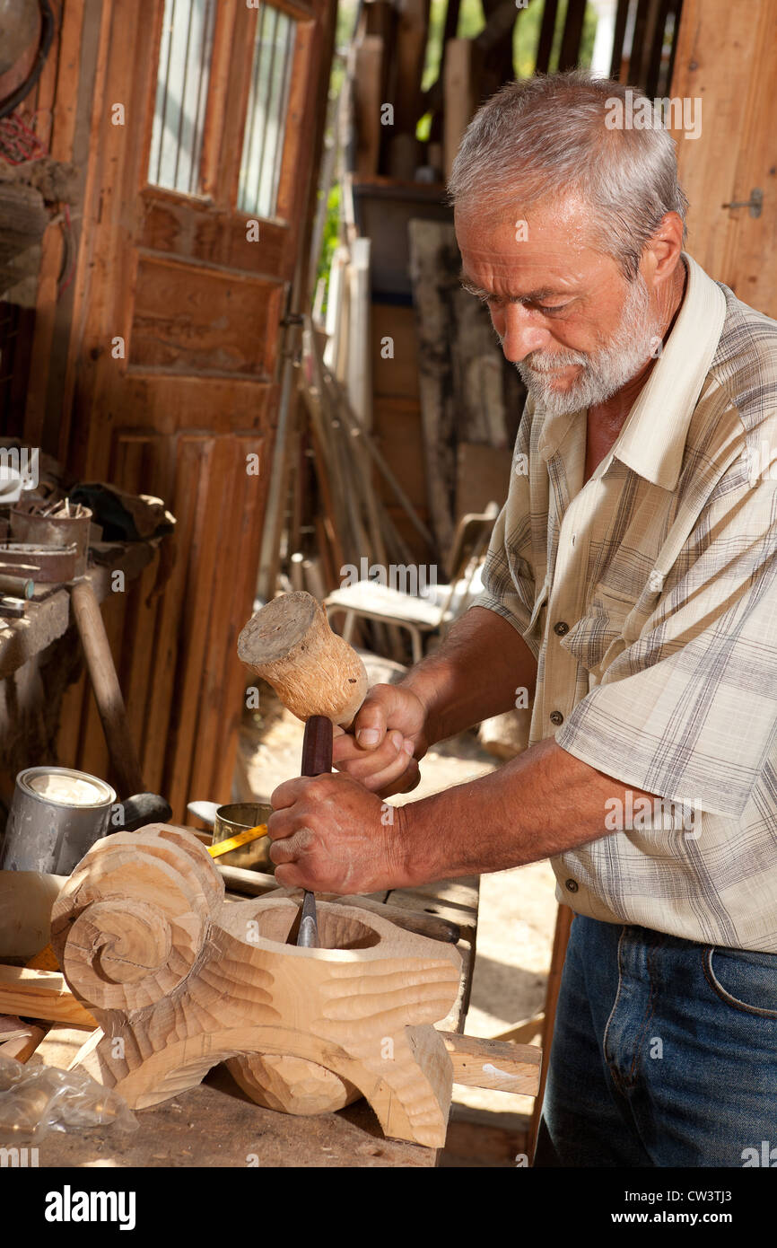 Skilled carpenter at work with hammer and chisel in an old shed Stock ...