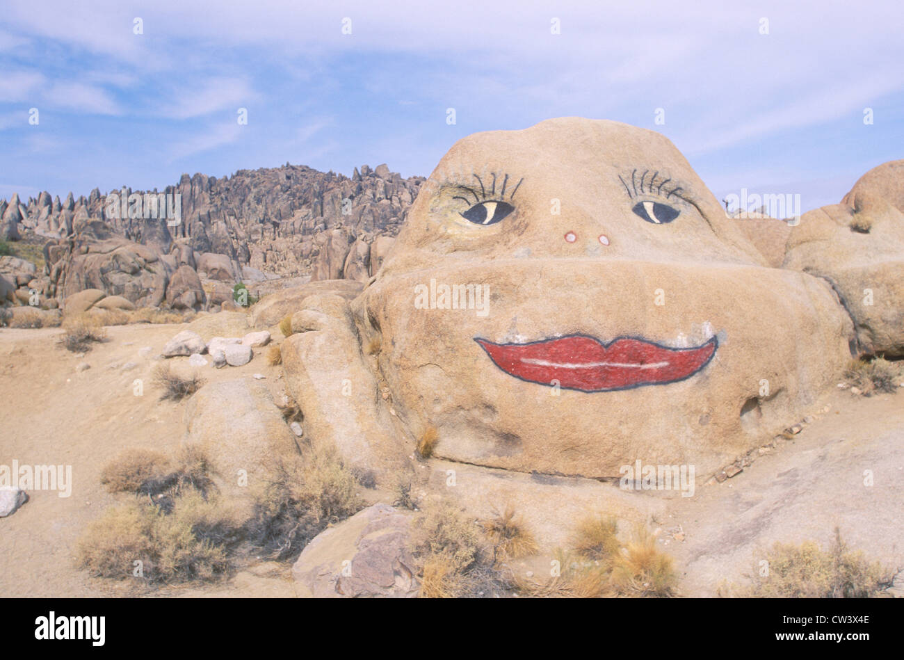 Red lips and woman's face painted on rock in Alabama Hills, California ...